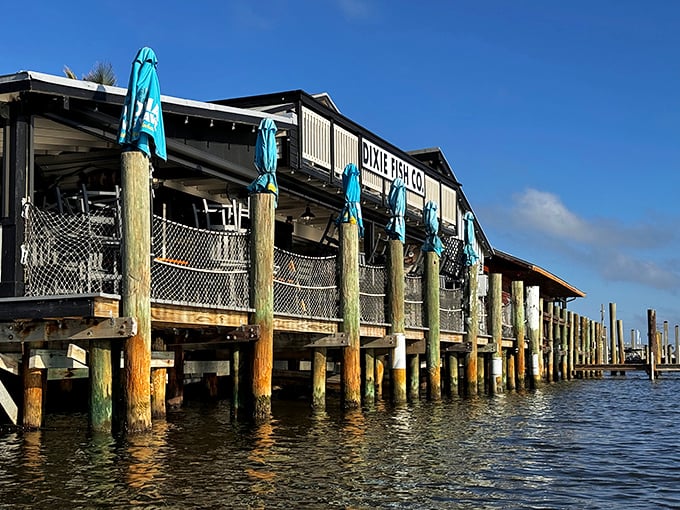 Perched over azure waters like a maritime mirage, this weathered beauty promises culinary treasures worth the journey.