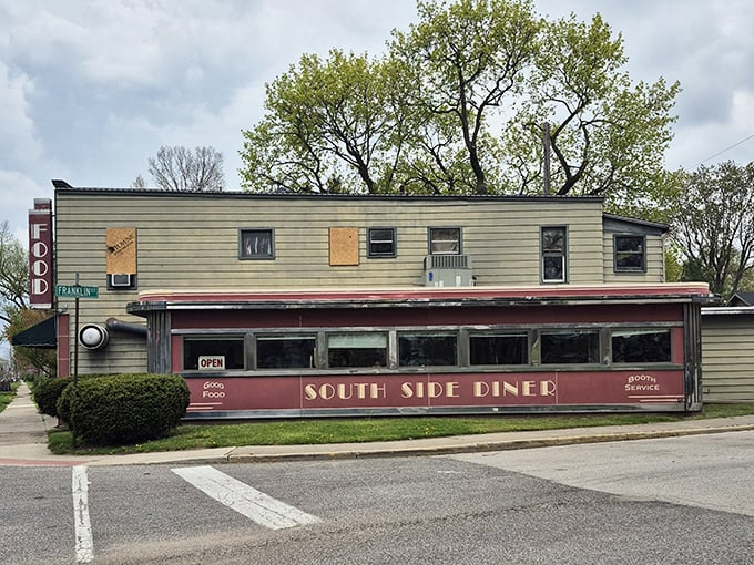 The red-trimmed facade isn't just a building, it's a promise of the Americana experience waiting inside—complete with outdoor seating for those perfect Indiana summer days.