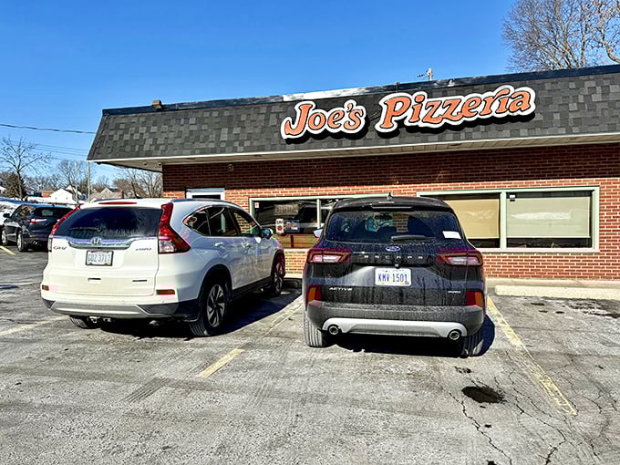 That classic orange sign against the brick façade isn't trying to impress anyone—it's too busy announcing where serious pizza lovers need to be.