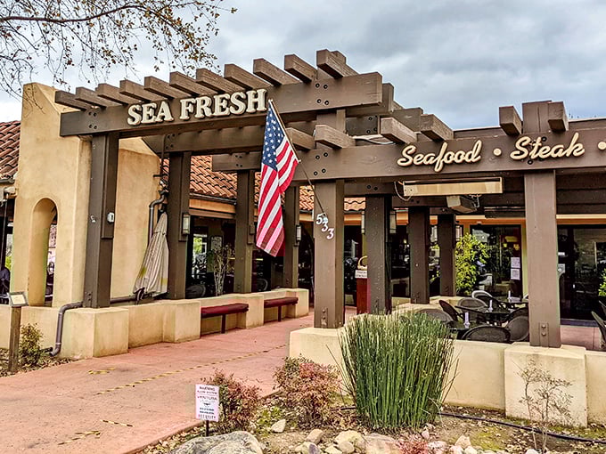 The welcoming pergola at Sea Fresh beckons like an old friend, promising seafood treasures under that rustic wooden frame and California sunshine.