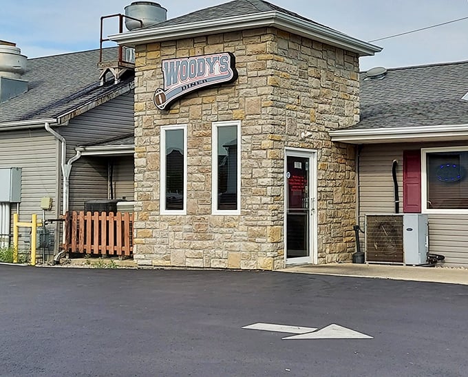 The stone facade of Woody's Diner stands like a culinary fortress, promising comfort food treasures within its unassuming walls.