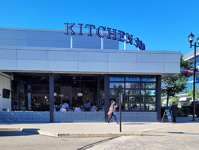 Kitchen Social's sleek exterior promises culinary adventures within. The modern brick and glass façade in Dublin's Bridge Park is like a well-dressed friend who always knows the best spots.