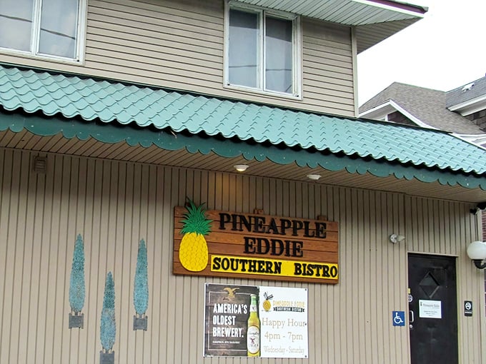 The teal-roofed treasure with its wooden pineapple sign beckons like a tropical oasis in Erie's urban landscape.