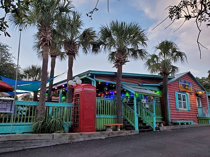 The weathered burgundy siding and turquoise trim scream "beach shack with attitude." This isn't where you go to impress a first date—it's where you take someone you actually like.
