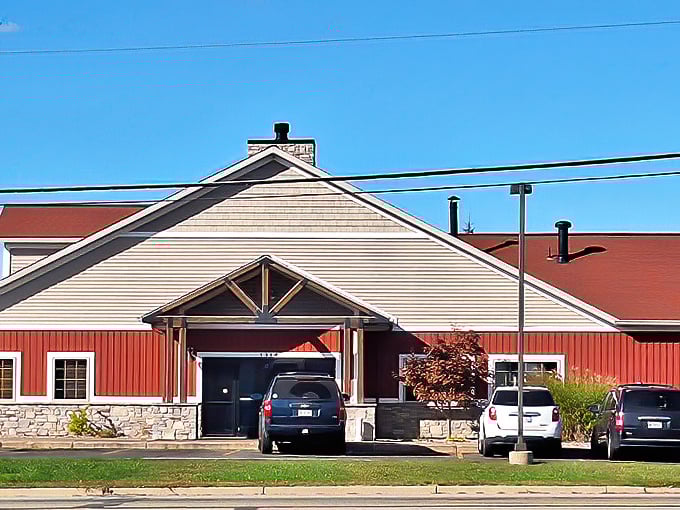 The barn-red exterior of Hop Hog isn't just eye-catching—it's a beacon for barbecue pilgrims seeking smoky salvation in Greenville's countryside.