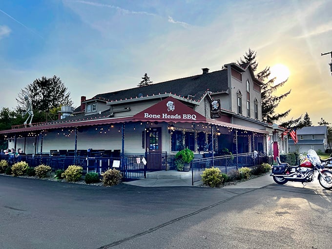 The historic charm of Bone Heads BBQ's exterior, complete with twinkling lights and wraparound porch, promises smoky delights within this Willis landmark.