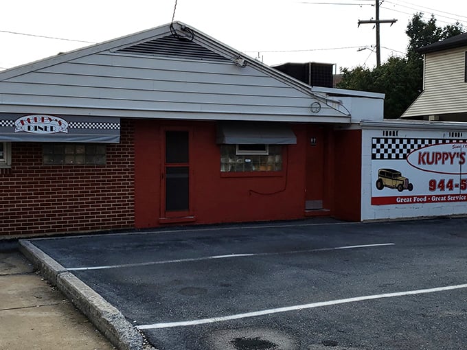 The unassuming exterior of Kuppy's Diner hides culinary treasures within. Like all great diners, it promises more on the inside than its modest façade suggests.