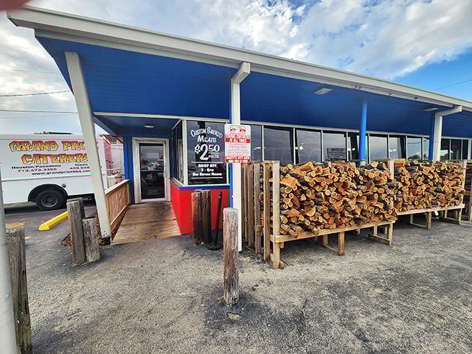 The entrance tells the whole story: serious wood for serious smoke. That stack isn't for show—it's tomorrow's flavor in waiting.