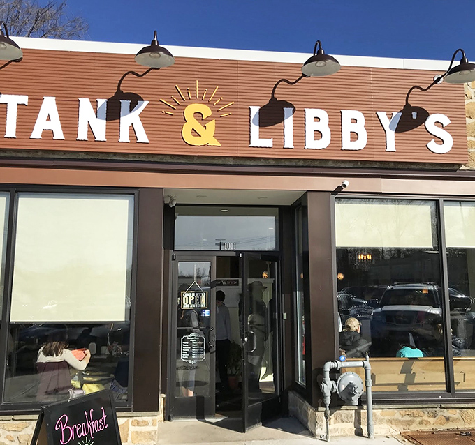 The sunshine-yellow ampersand between "TANK & LIBBY'S" isn't just cheerful decoration—it's a promise that something special awaits behind those bamboo-shaded windows.