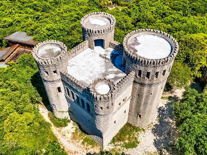 From above, Castle Otttis resembles a medieval chess piece dropped into Florida's lush landscape—a stone sentinel guarding secrets beneath its weathered towers.