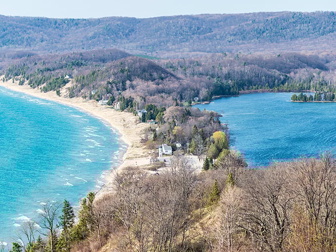 Nature's perfect sandwich: South Bar Lake nestled between lush forests and Lake Michigan's vast blue horizon. Michigan's geography showing off like it's auditioning for National Geographic.