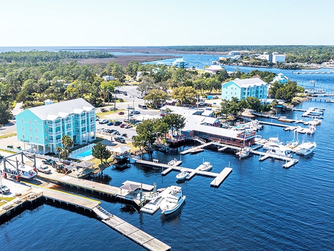 Turquoise buildings stand like tropical sentinels overlooking a marina where adventure begins and fish stories are born.