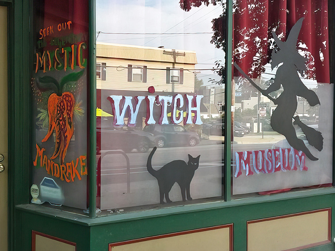 The storefront beckons with whimsical window art—a silhouette witch rides her broom alongside a curious black cat. Magic hides in plain sight on this ordinary Cleveland street.