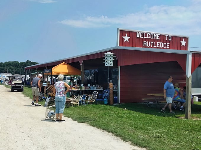 The iconic red barn entrance to Rutledge Flea Market stands like a gateway to treasure hunting paradise, welcoming bargain seekers with Midwestern charm.