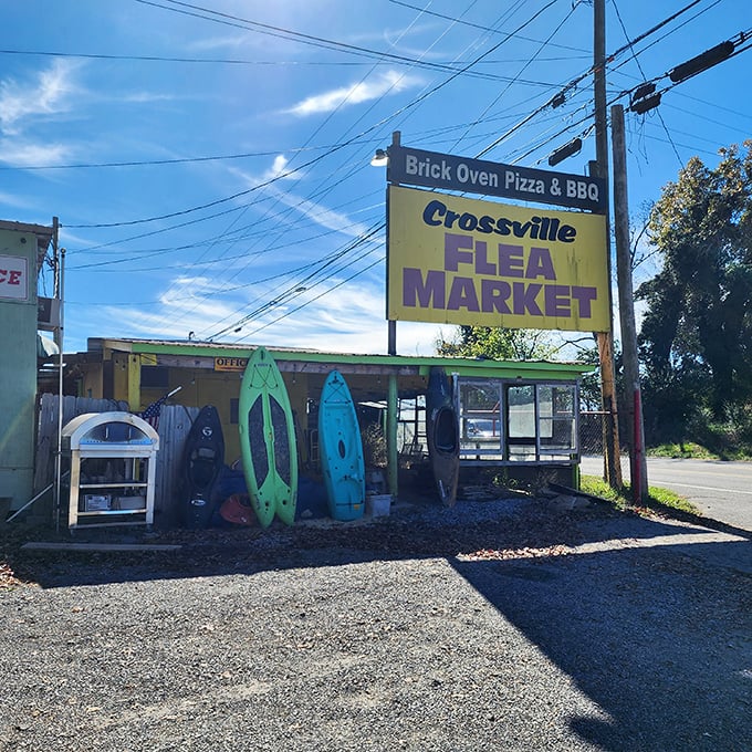 The iconic yellow sign welcomes treasure hunters to Crossville Flea Market, where kayaks stand ready for their next adventure—or your backyard.