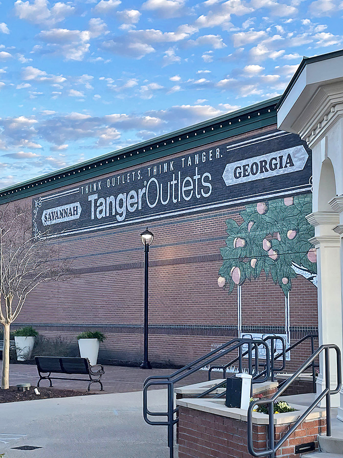 The iconic Tanger Outlets sign welcomes shoppers under Georgia's impossibly blue sky, promising retail therapy and wallet-lightening experiences ahead.