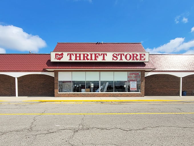 Under clear blue skies, the bold red signage beckons like a lighthouse for the budget-conscious shopper seeking hidden gems.