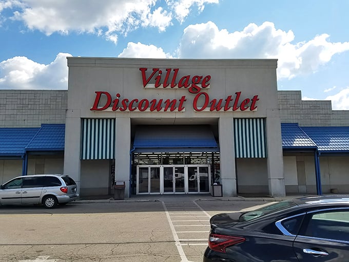 The iconic red signage of Village Discount Outlet stands out against the Dayton sky, a beacon for bargain hunters and treasure seekers alike.