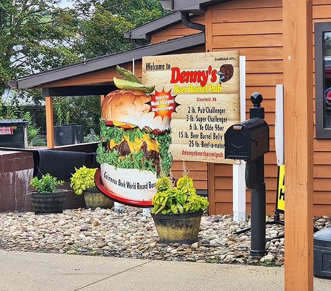The legendary burger monument outside Denny's Beer Barrel Pub announces your arrival to burger paradise. This isn't just signage—it's a warning of the delicious challenges that await inside.