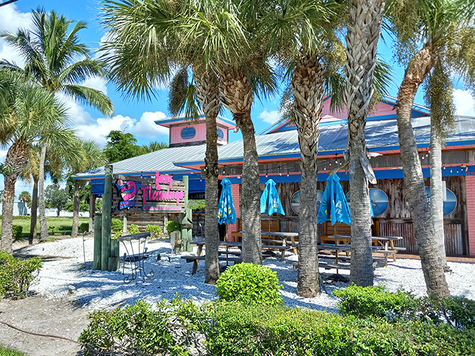 The Lazy Flamingo's cheerful exterior promises Florida fun with its bright blue trim and red railings—a casual seafood haven hiding in plain sight.
