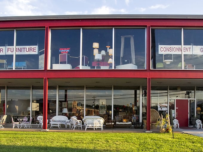 The distinctive red-trimmed exterior of Red Door Consignment Gallery stands out like a beacon for bargain hunters, promising treasures within those large display windows.