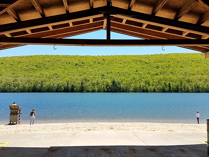 The view from the pavilion feels like nature's widescreen TV – mountains, water, and sky in perfect high-definition harmony.