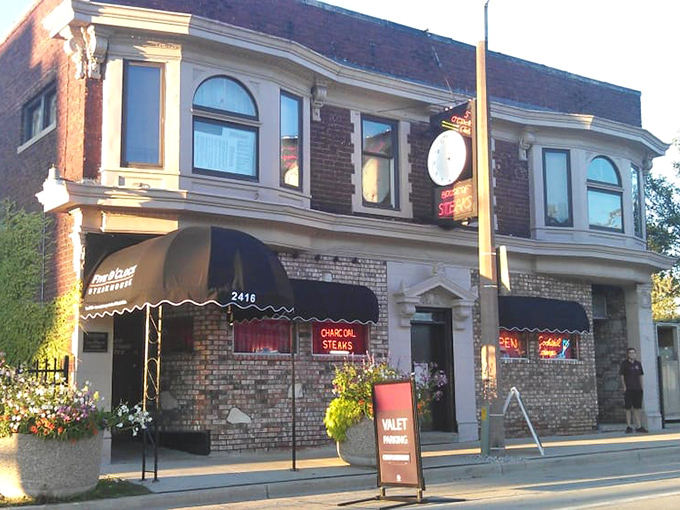 The brick façade of Five O'Clock Steakhouse stands like a time capsule on Milwaukee's West State Street, its neon sign beckoning hungry carnivores since the Truman administration.