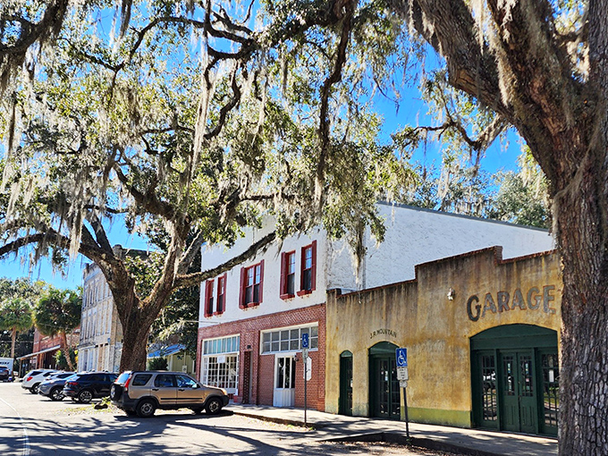 Cholokka Boulevard's historic storefronts stand frozen in time, where Spanish moss-draped oaks provide natural awnings over brick and mortar memories. 