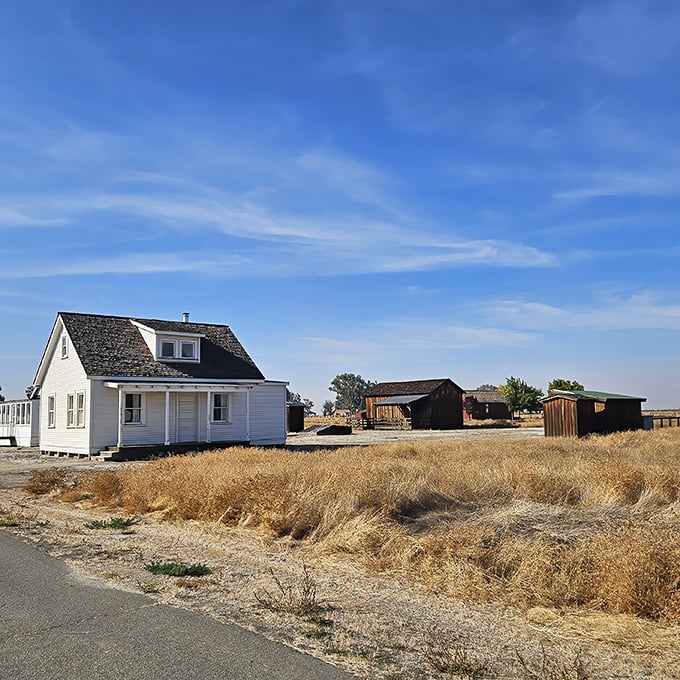 White clapboard buildings stand sentinel against the vast Central Valley sky, telling a story of ambition, hope, and determination in California's historic African American township.