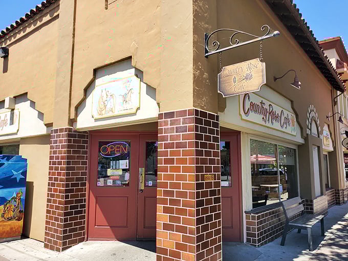 The corner spot that launched a thousand breakfast pilgrimages. Country Rose Café's Spanish-style exterior promises culinary treasures within.
