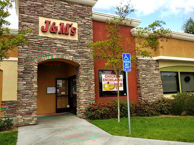 The stone facade of J & M's welcomes hungry travelers like a culinary lighthouse, promising comfort food salvation just steps away.