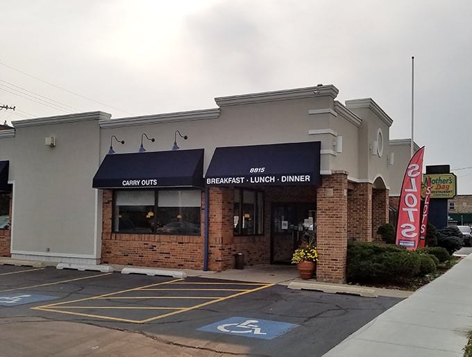 The unassuming exterior of Mother's Day Restaurant hides a breakfast paradise within. Navy awnings and brick façade set the stage for comfort food magic.