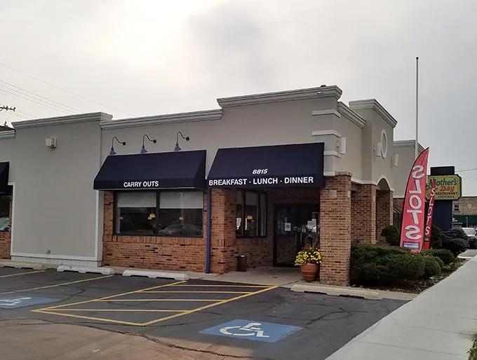 The unassuming exterior of Mother's Day Restaurant hides a breakfast paradise within. Navy awnings and brick façade set the stage for comfort food magic.