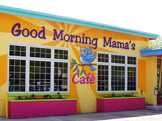 The sunshine-yellow exterior with that blue bird logo isn't just a restaurant—it's a mood-altering device disguised as a building.