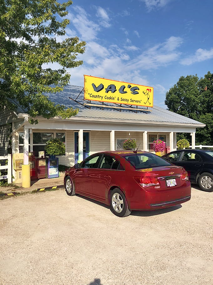 The bright yellow sign promises "Country Cookin' & Sassy Servers" – a combination that's as irresistible as it is honest.