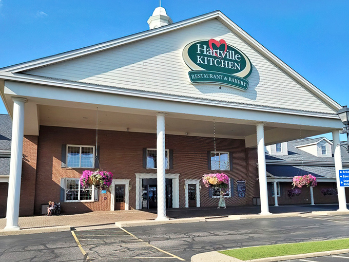 The white-columned entrance to Hartville Kitchen stands like a culinary Parthenon, promising Midwestern ambrosia within those brick walls.