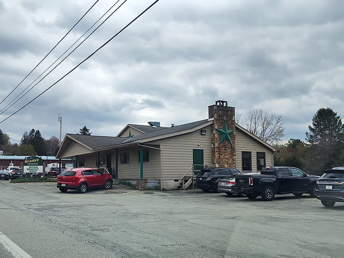 Brady's Restaurant stands unassumingly along the roadside, its simple beige exterior and stone chimney hiding culinary treasures that locals have treasured for generations.