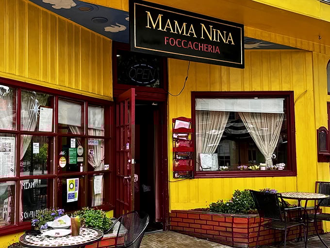 That cheerful yellow facade practically shouts "Come in and eat!" – Italian hospitality begins before you even cross the threshold.