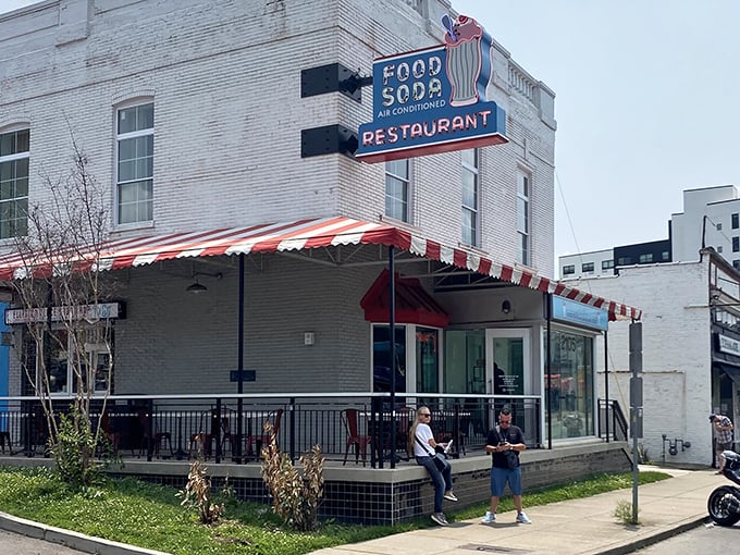 That classic red and white striped awning isn't just decoration—it's a beacon calling to anyone with a hankering for authentic diner magic.