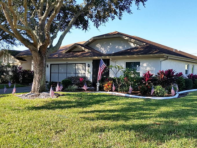 Well-maintained homes with American flags dotting the landscape – Florida retirement living that doesn't sacrifice patriotism or curb appeal.