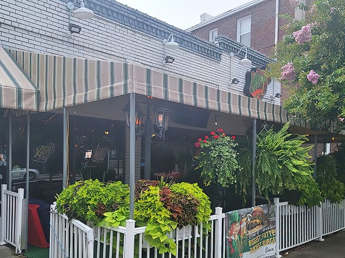 The welcoming façade features vibrant flower boxes and greenery, making the outdoor patio a coveted spot for people-watching while enjoying a meal.