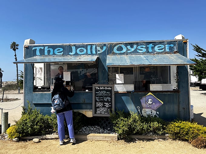 The weathered blue shack with "The Jolly Oyster" painted across the top isn't trying to impress anyone—until you taste what's inside. California coastal dining at its most honest.
