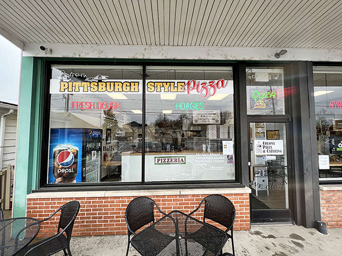 "Pittsburgh Style Pizza" proudly announces itself through the window, a siren call to hungry passersby seeking authentic regional flavor.