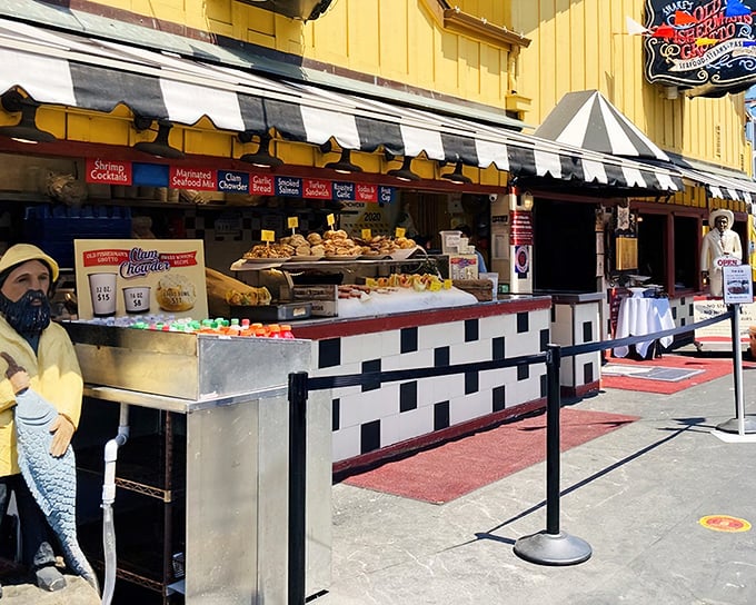 The cheerful yellow exterior of Old Fisherman's Grotto stands like a beacon on Monterey's wharf, promising seafood treasures within those striped-awning doors.