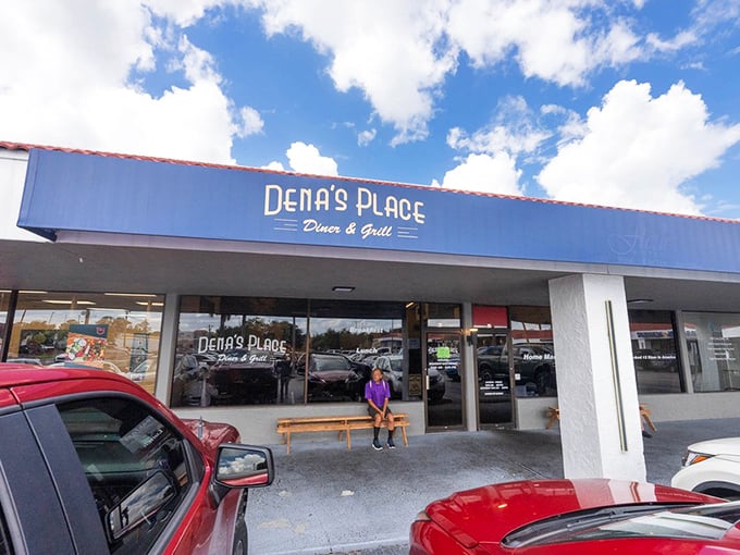 A simple wooden bench outside Dena's Place – where the brief wait for a table becomes part of the experience. Florida's hidden gems often come with the most unassuming entrances.