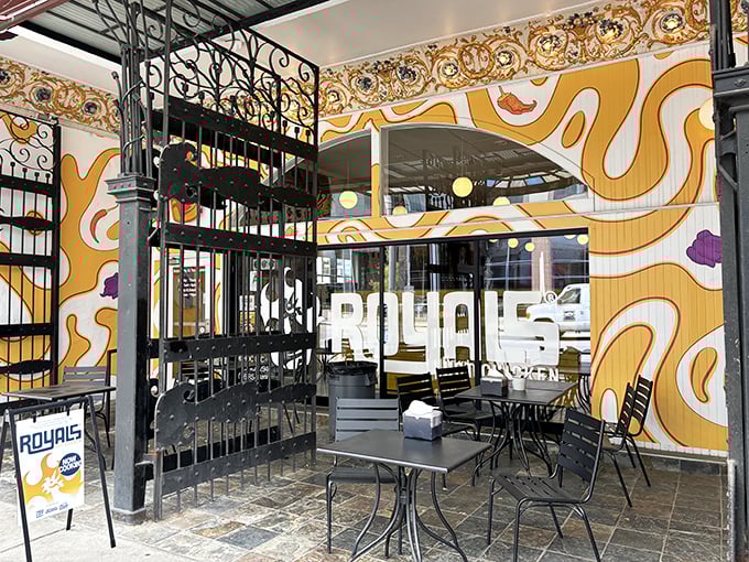 The vibrant exterior screams "food adventure ahead!" with its playful crown logo and bold orange swirls—Louisville's artistic spirit meets Nashville heat.