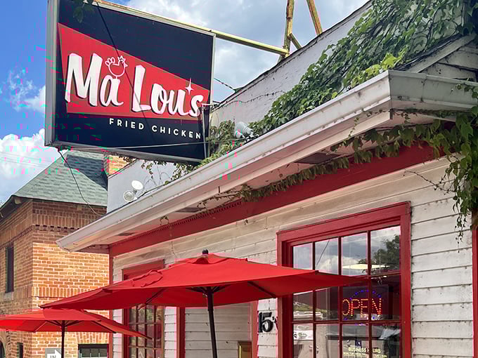The white clapboard building with bold red trim isn't just eye-catching—it's a beacon for fried chicken pilgrims seeking salvation in crispy, juicy form.