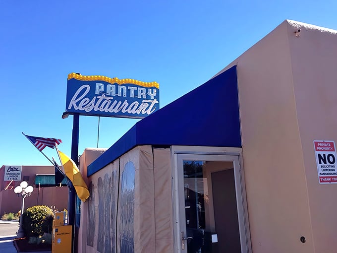 That iconic blue awning and vintage sign against the New Mexico sky – like a beacon calling all hungry travelers home.