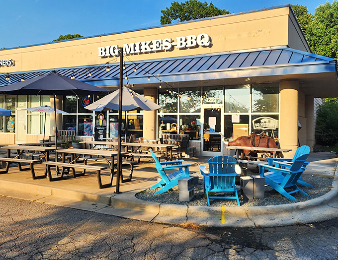 The unassuming storefront with those bright blue Adirondack chairs is like a beacon for BBQ pilgrims. This isn't just a meal—it's a destination.
