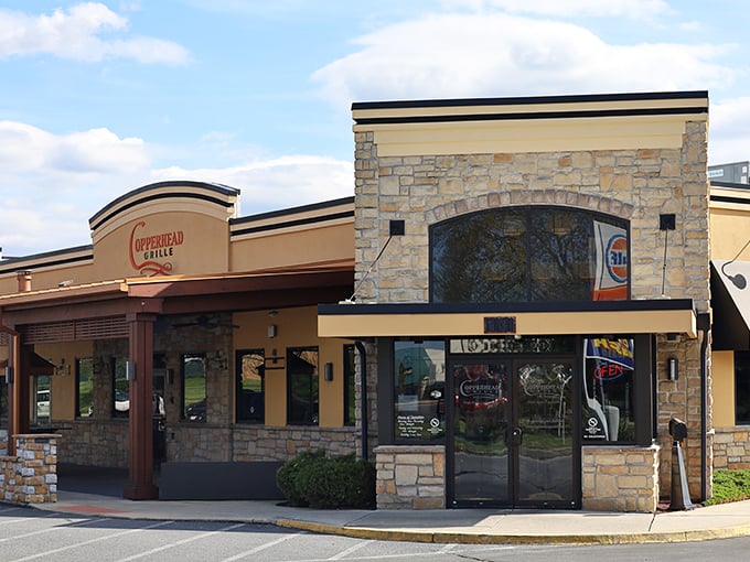 The unassuming exterior of Copperhead Grille hides culinary treasures within, like finding a secret food paradise behind stone and stucco.